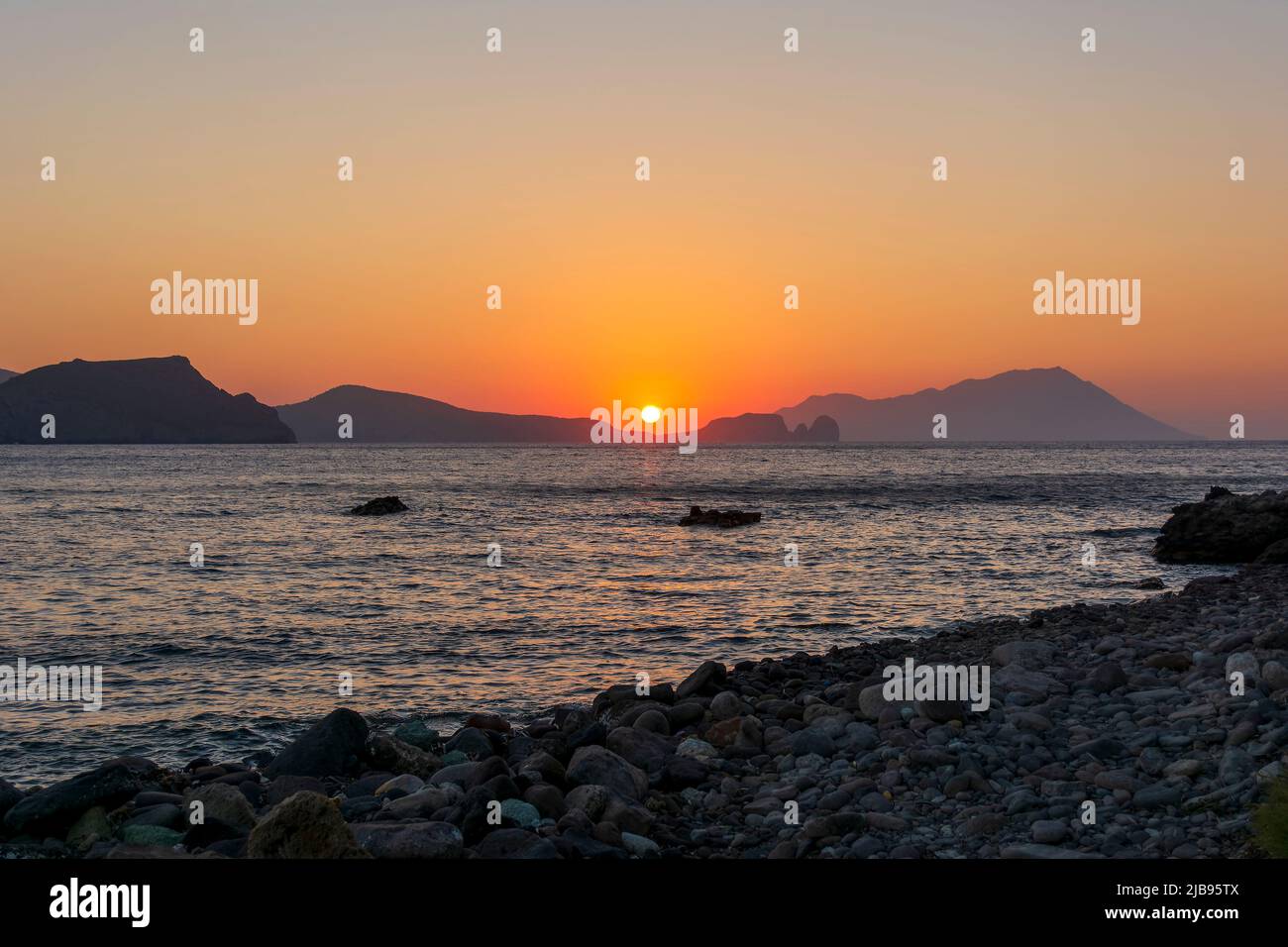 Beautiful sunset at a beach of Greek island of Milos Stock Photo - Alamy