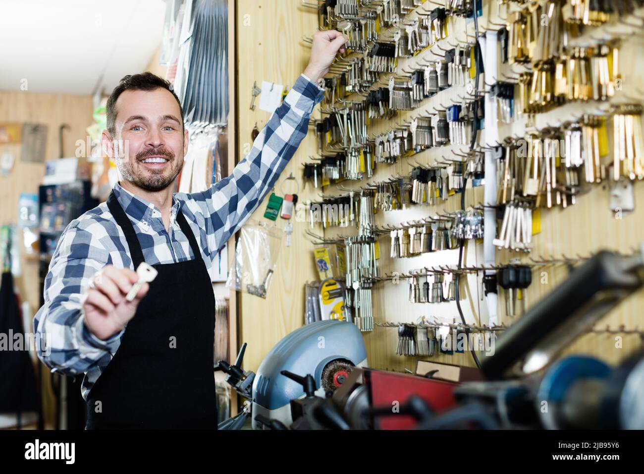 Worker displaying result of his key forming in workplace Stock Photo ... Worker displaying result of his key forming in workplace Stock Photo ...