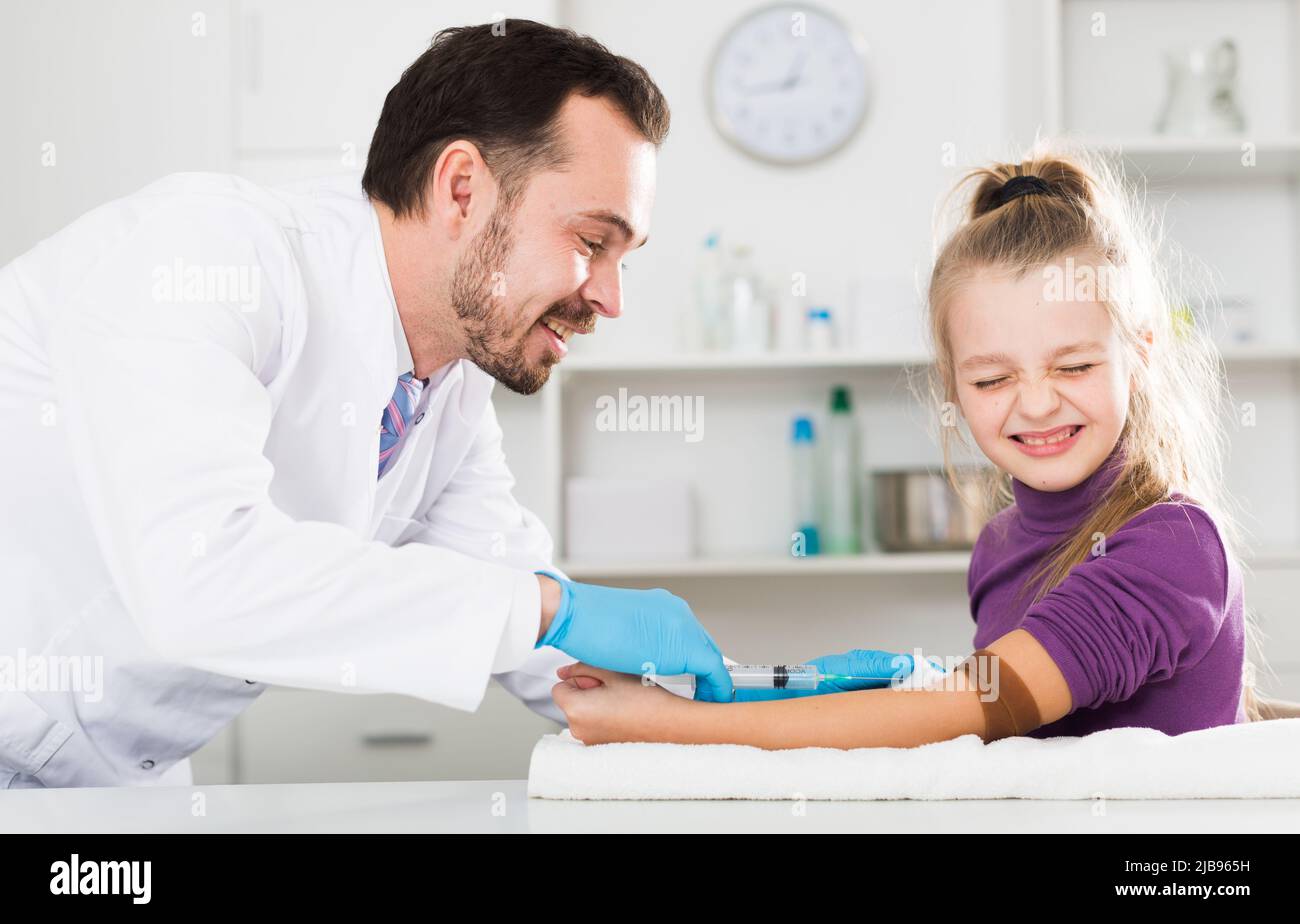 Male doctor injecting little patient Stock Photo - Alamy