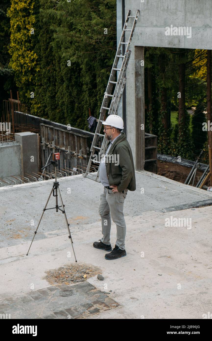 Geodetic works. Surveyor engineer using geodetic equipment at ...