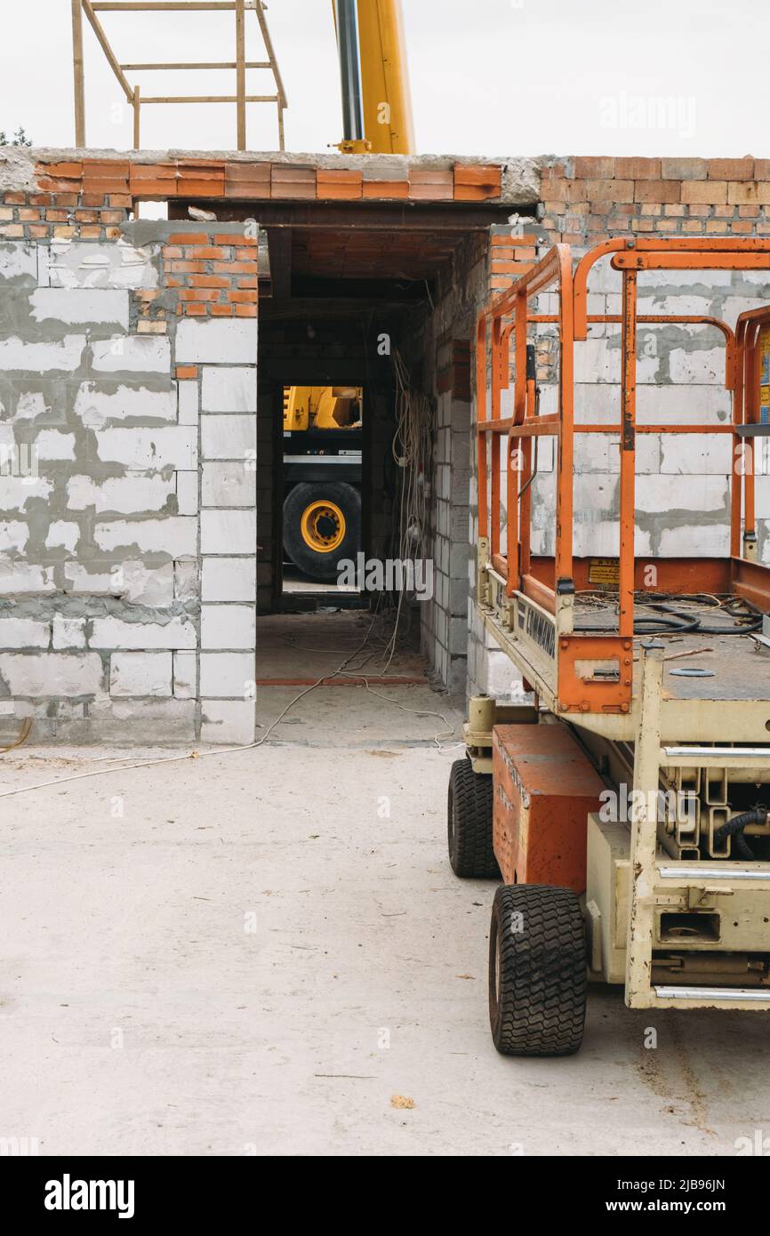 Scissor Lift Platform on a construction site. Building concreate house ...