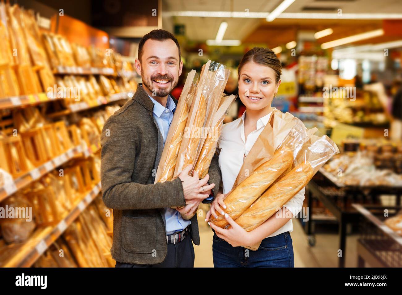 couple is standing with purchases in bread department Stock Photo - Alamy