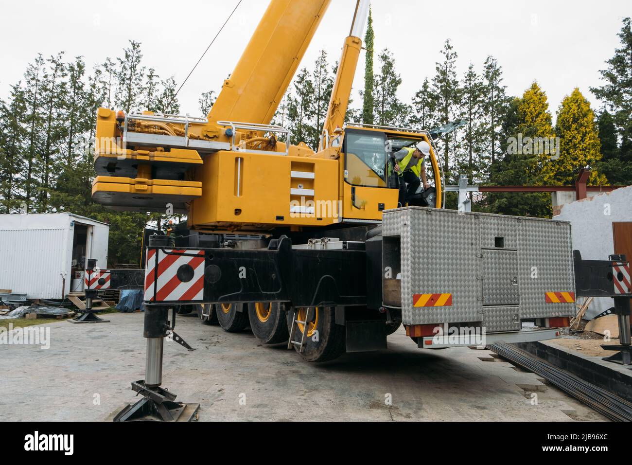 Operator on Construction crane lifting heavy freight. Modern mobile ...