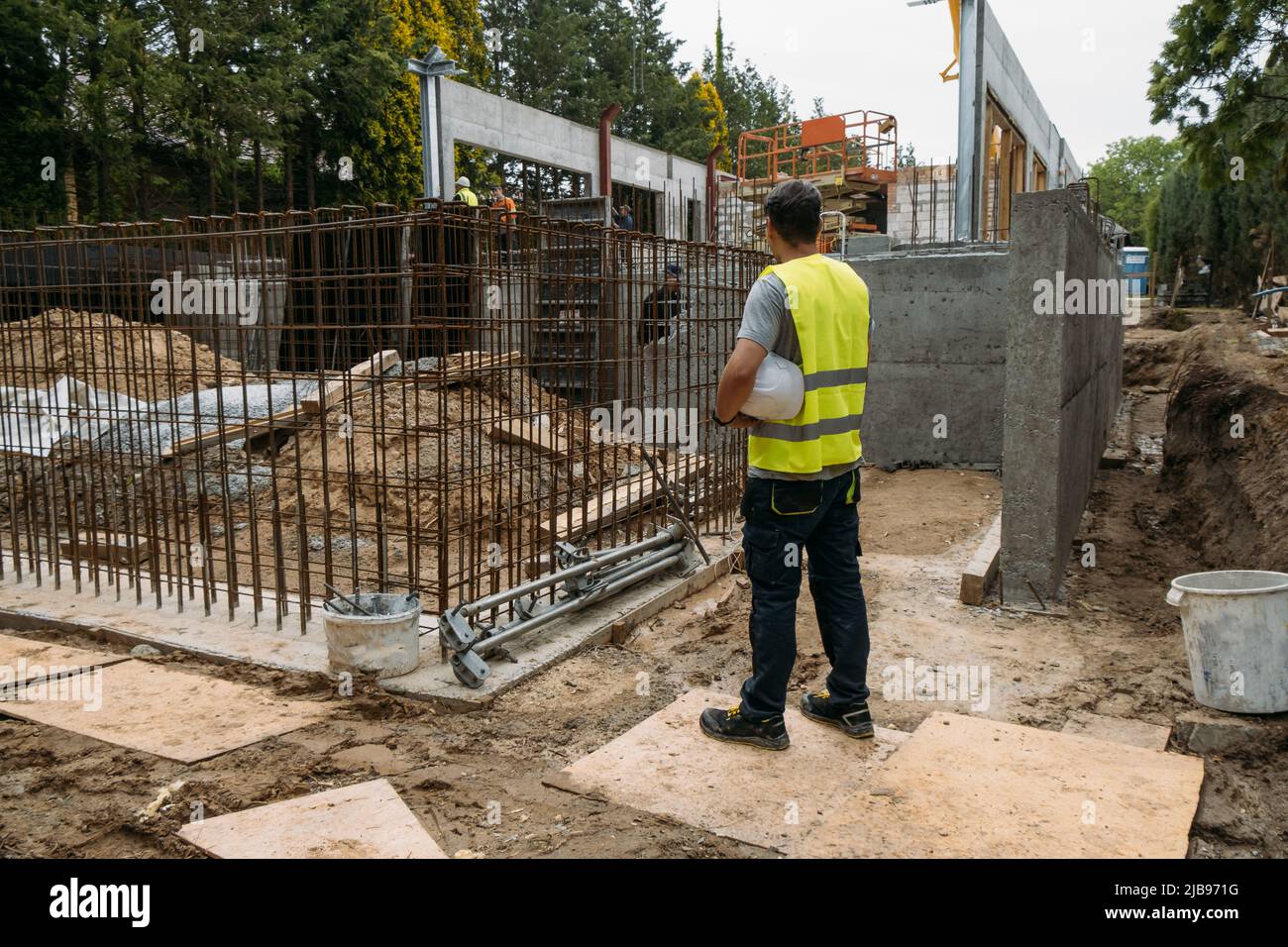 man working with helmet from the back at construction site building ...