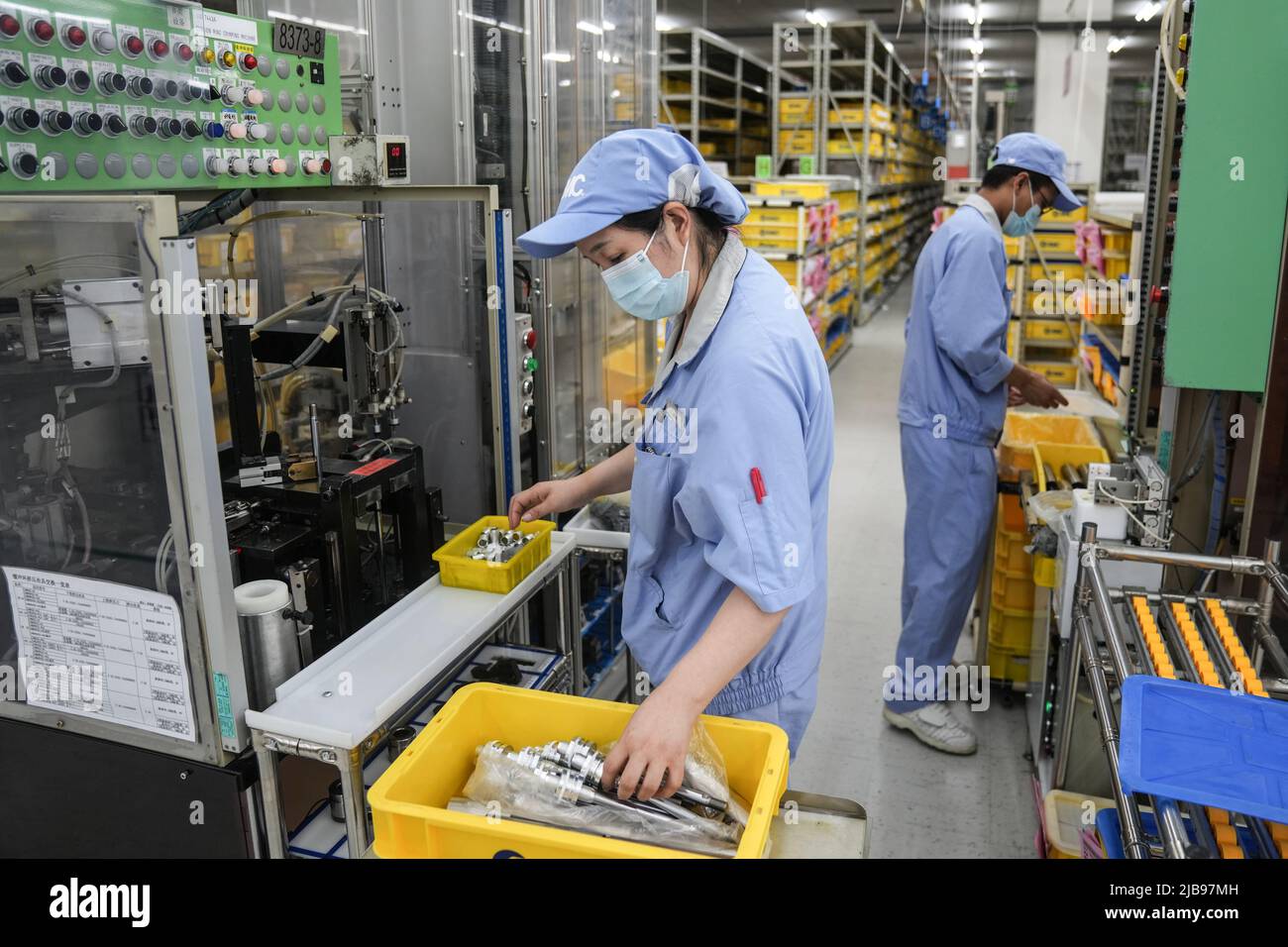 Beijing, China. 4th June, 2022. Staff members work at a factory of SMC ...