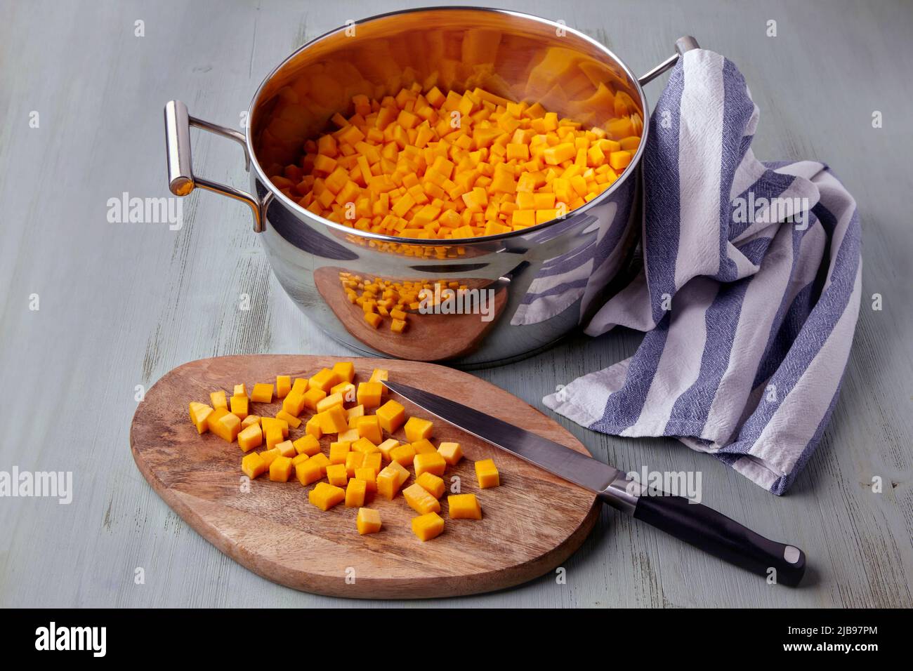 Cut the pumpkin into cubes on a cutting board and in a saucepan. Making ...