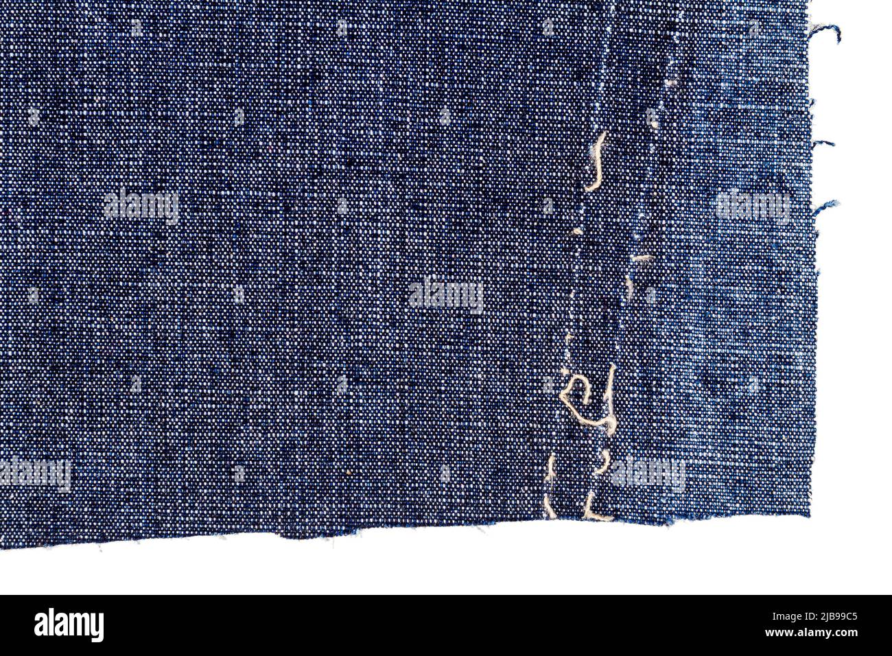 Piece of blue jeans fabric with a ripped of back pocket isolated on ...