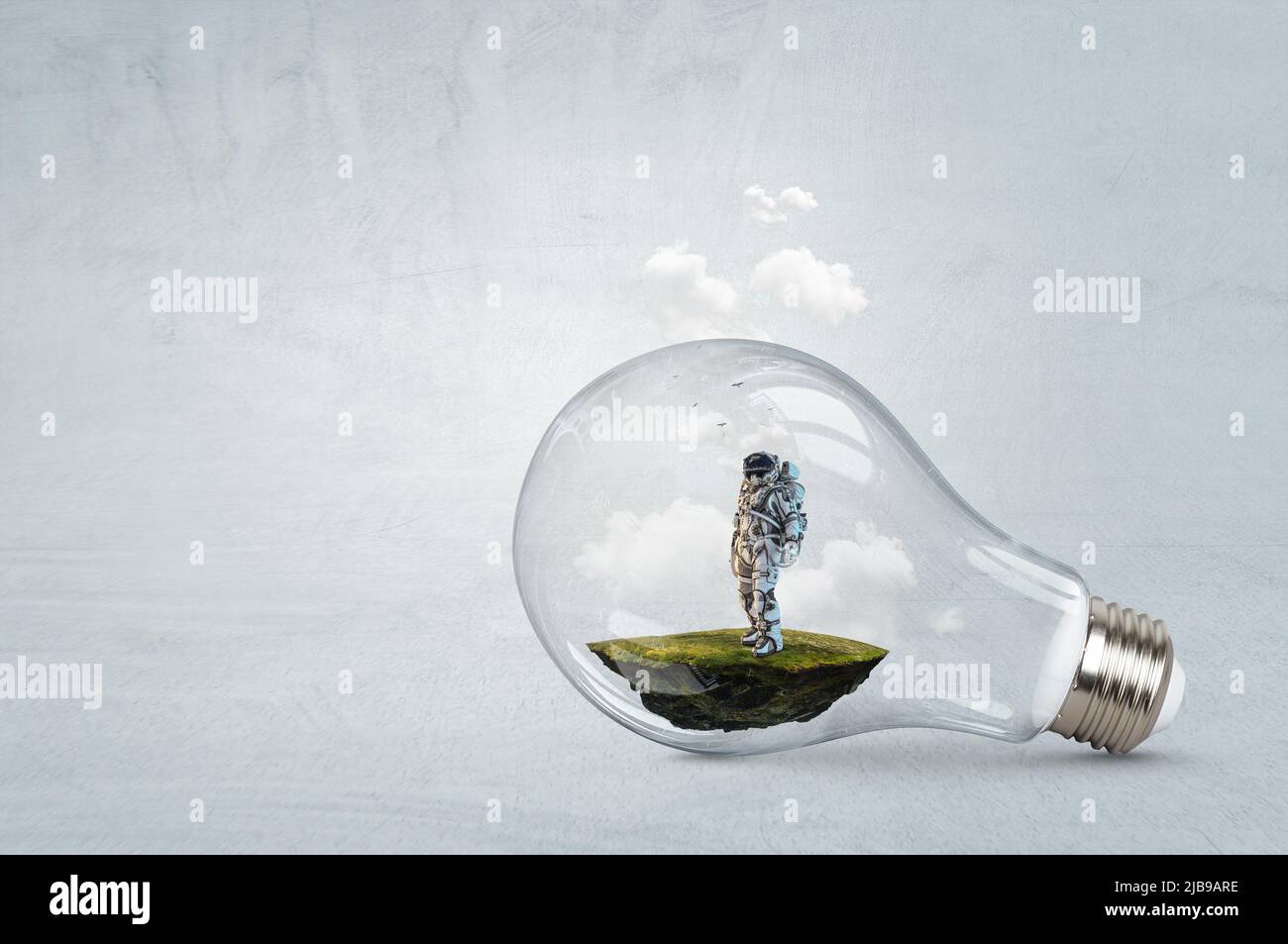 Spaceman inside light bulb . Mixed media Stock Photo - Alamy
