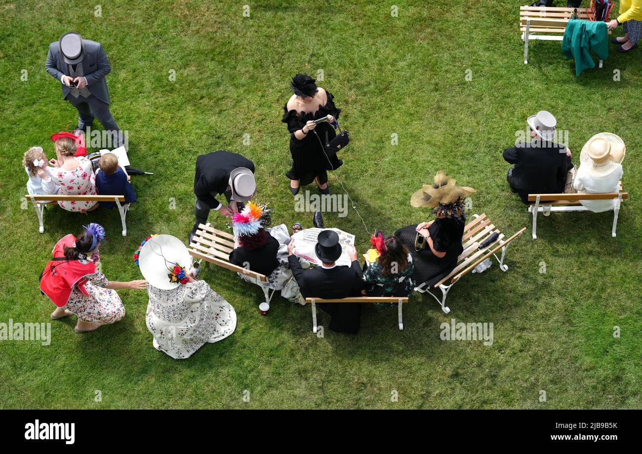 Race goers relax prior to the start of racing on Derby Day during the ...