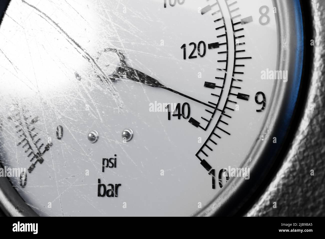 Round temperature gauge isolated on a black panel. Circular barometer ...