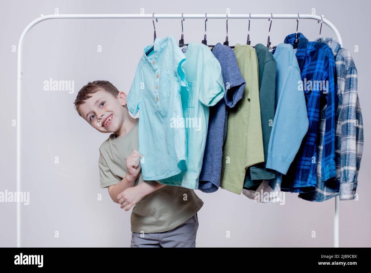 Boy preschooler standing hangers racks hi-res stock photography and ...