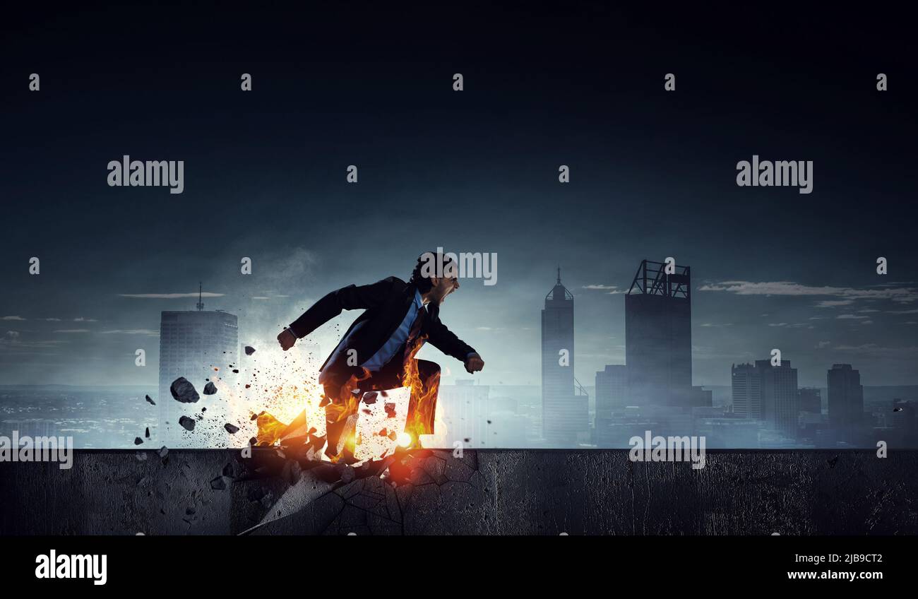Determined businessman leaving fire trails on asphalt Stock Photo - Alamy