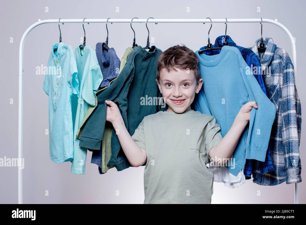 Boy preschooler standing hangers racks hi-res stock photography and ...