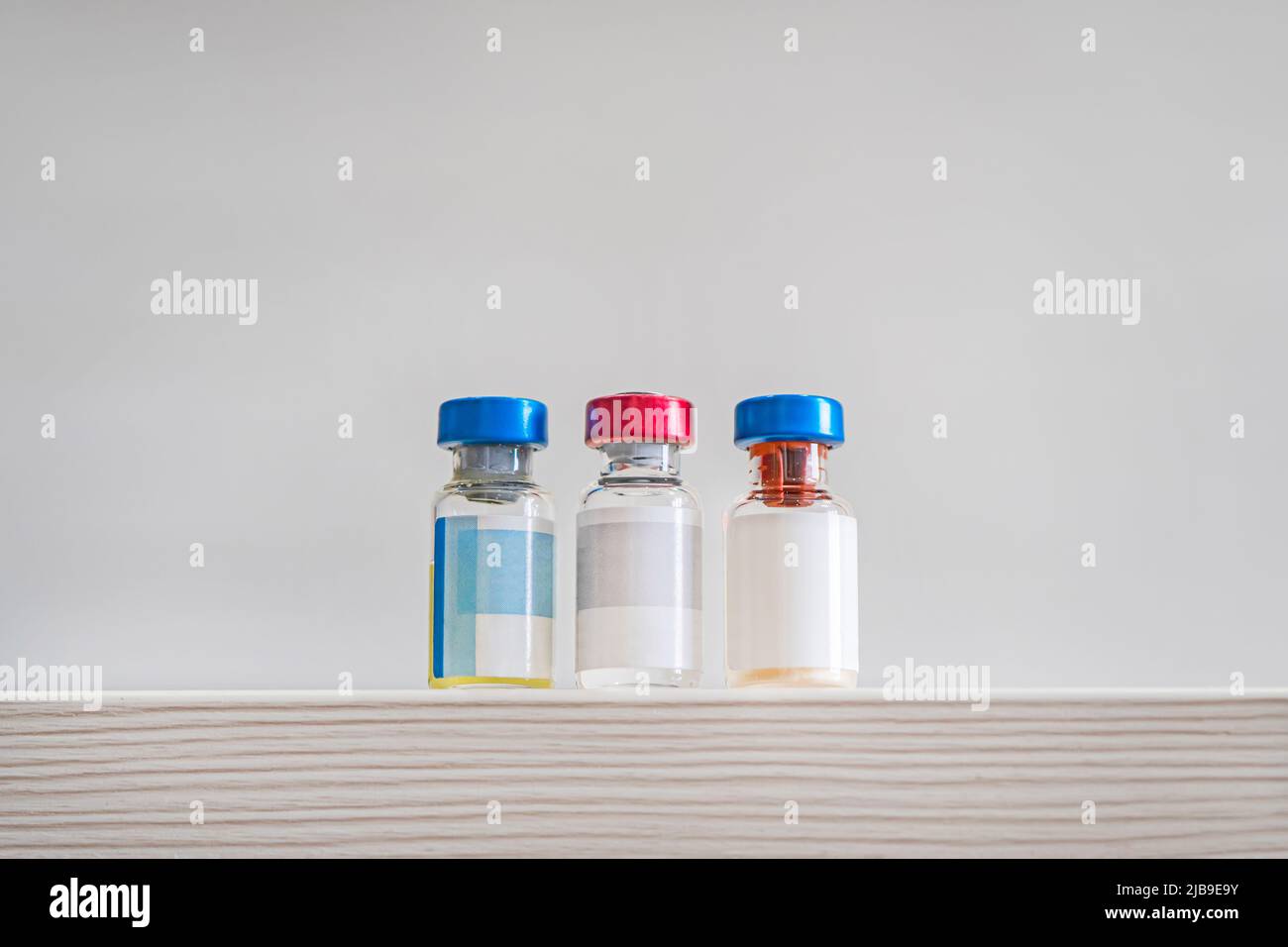 medical vaccine vials or bottles on table top over gray background ...