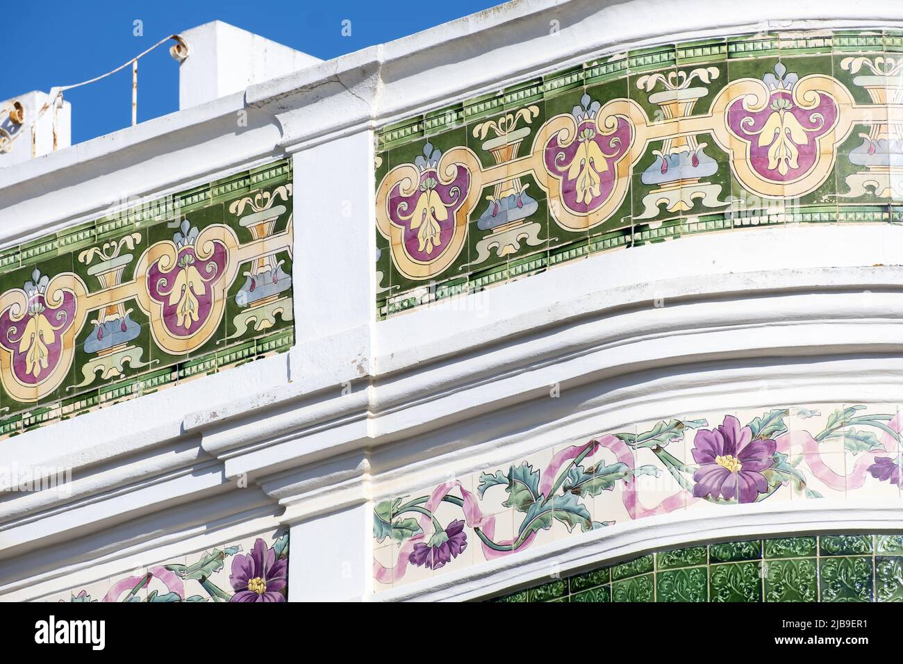 House with green ceramic tiles and azulejo frieze representing flowers ...