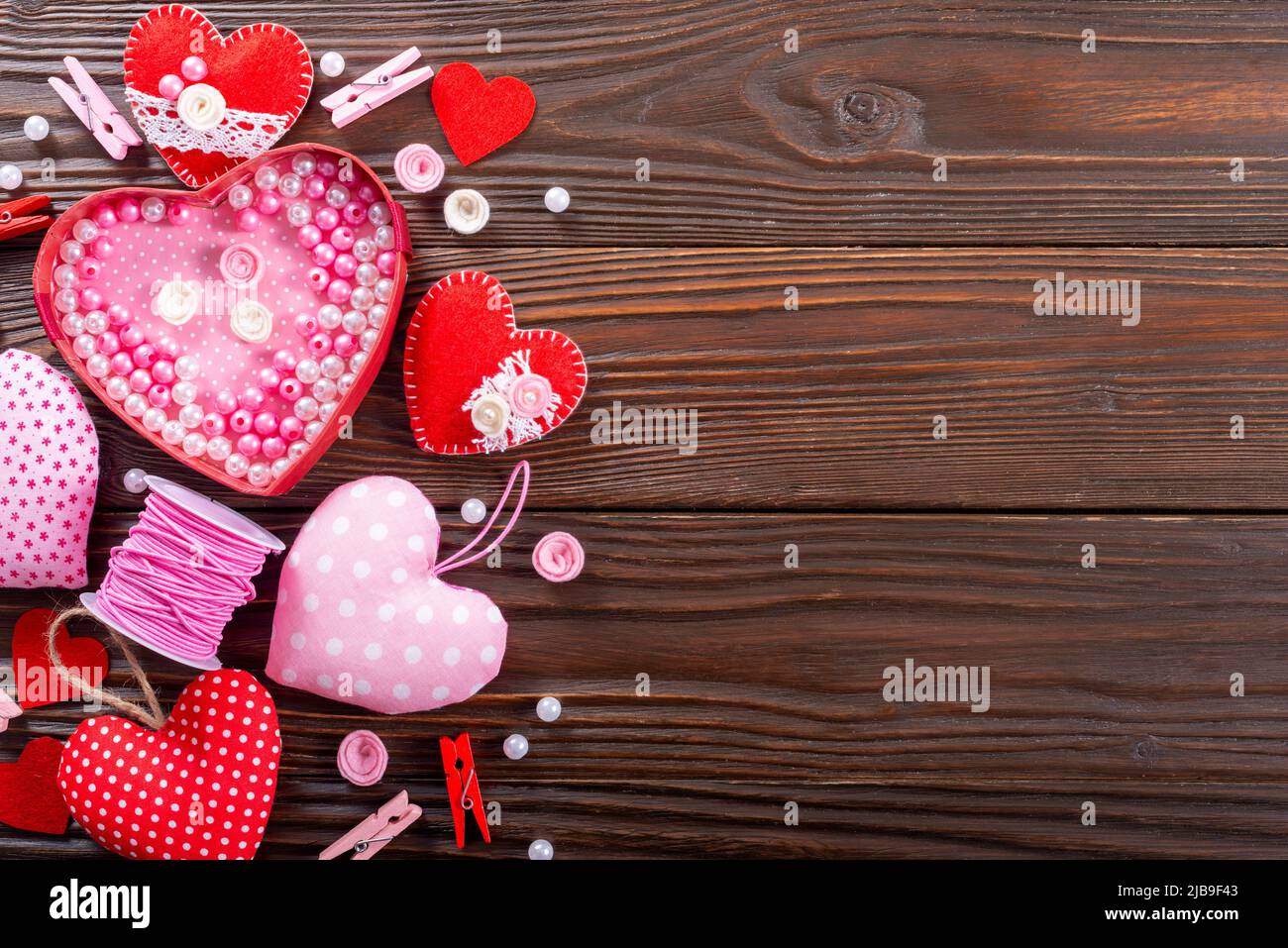 DIY Valentine hearts laundry pins and sewing spool on wooden table flat ...