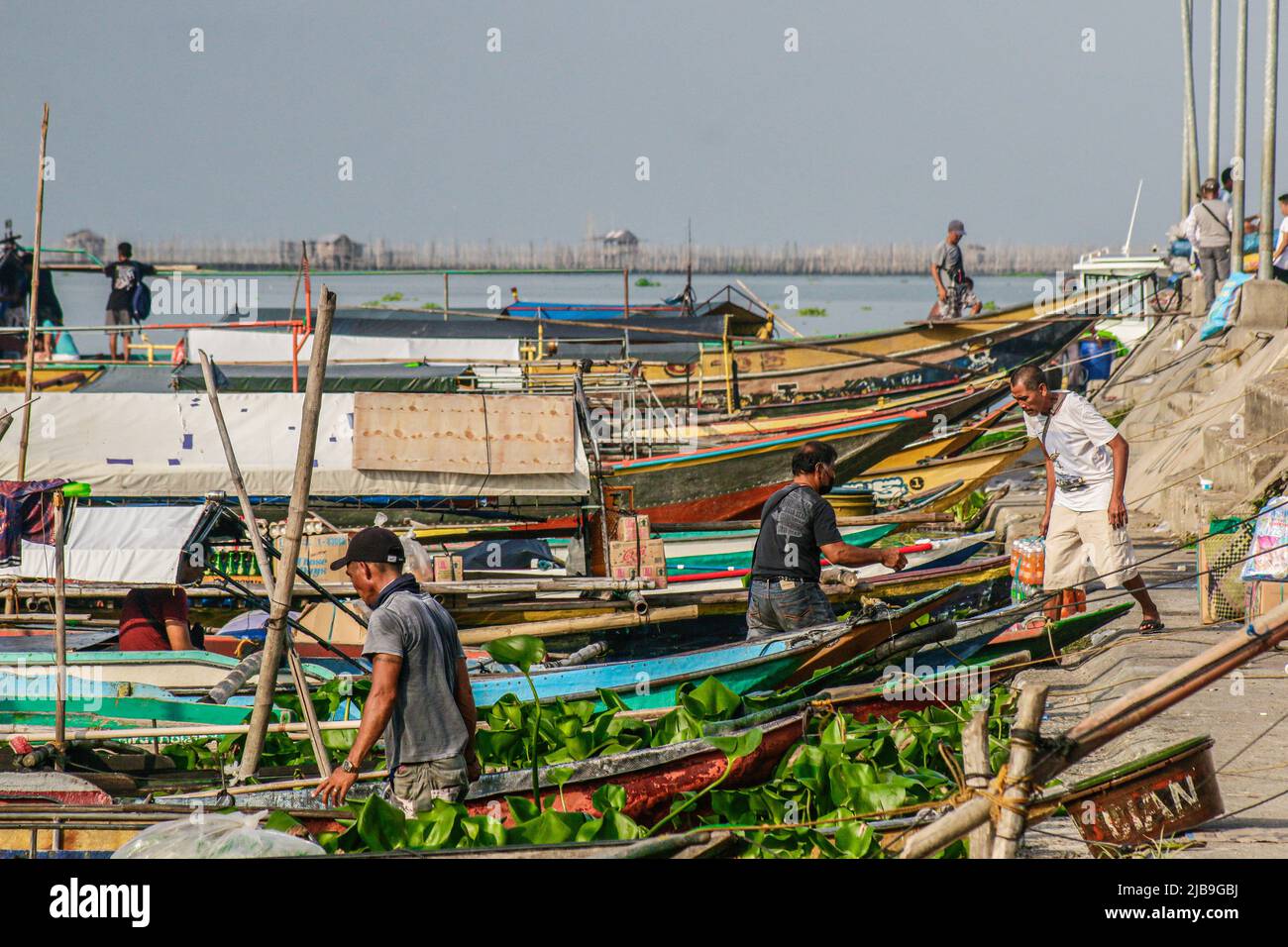 Fishermen anchor their boats at a fish port. Laguna Lake is the largest ...
