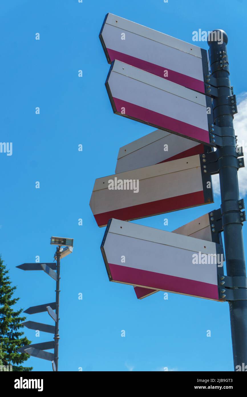 Blank directional road signs against blue sky. Directional sign post ...