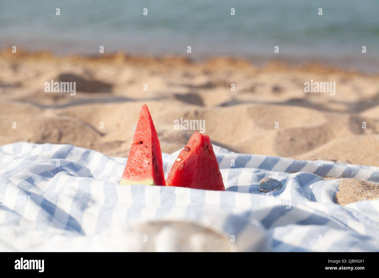 Watermelon on the beach on a sea background. Tropical fruits, healthy ...