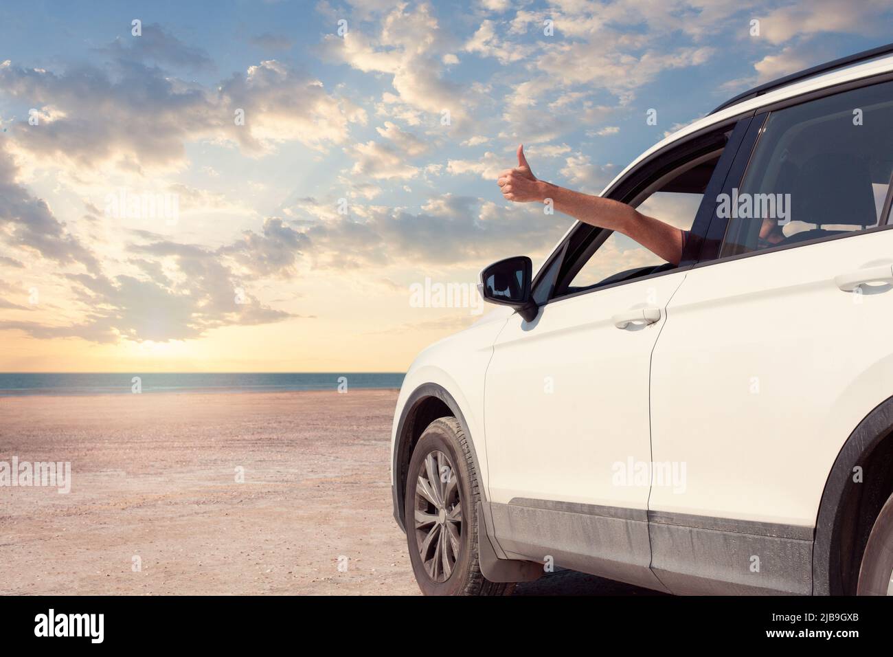Happy man hand out window car against sky, clouds and sea Stock Photo ...