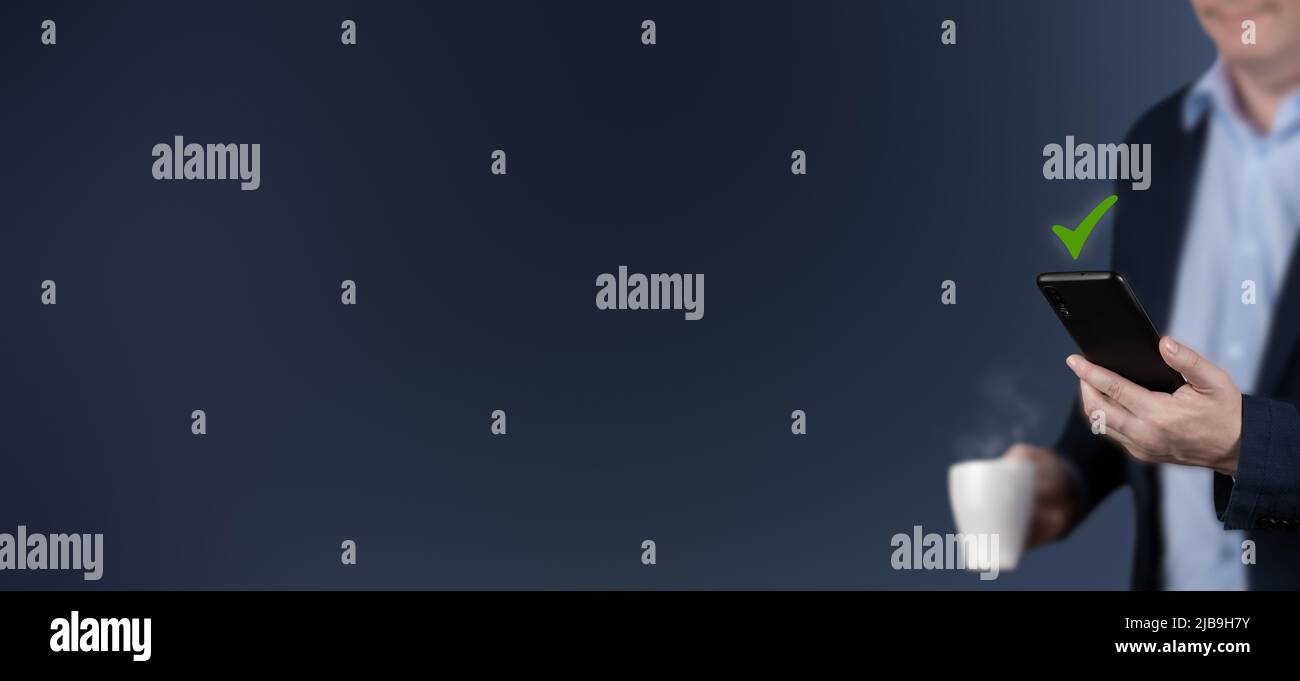 businessman holding cell phone with green tick, accepted confirmation ...