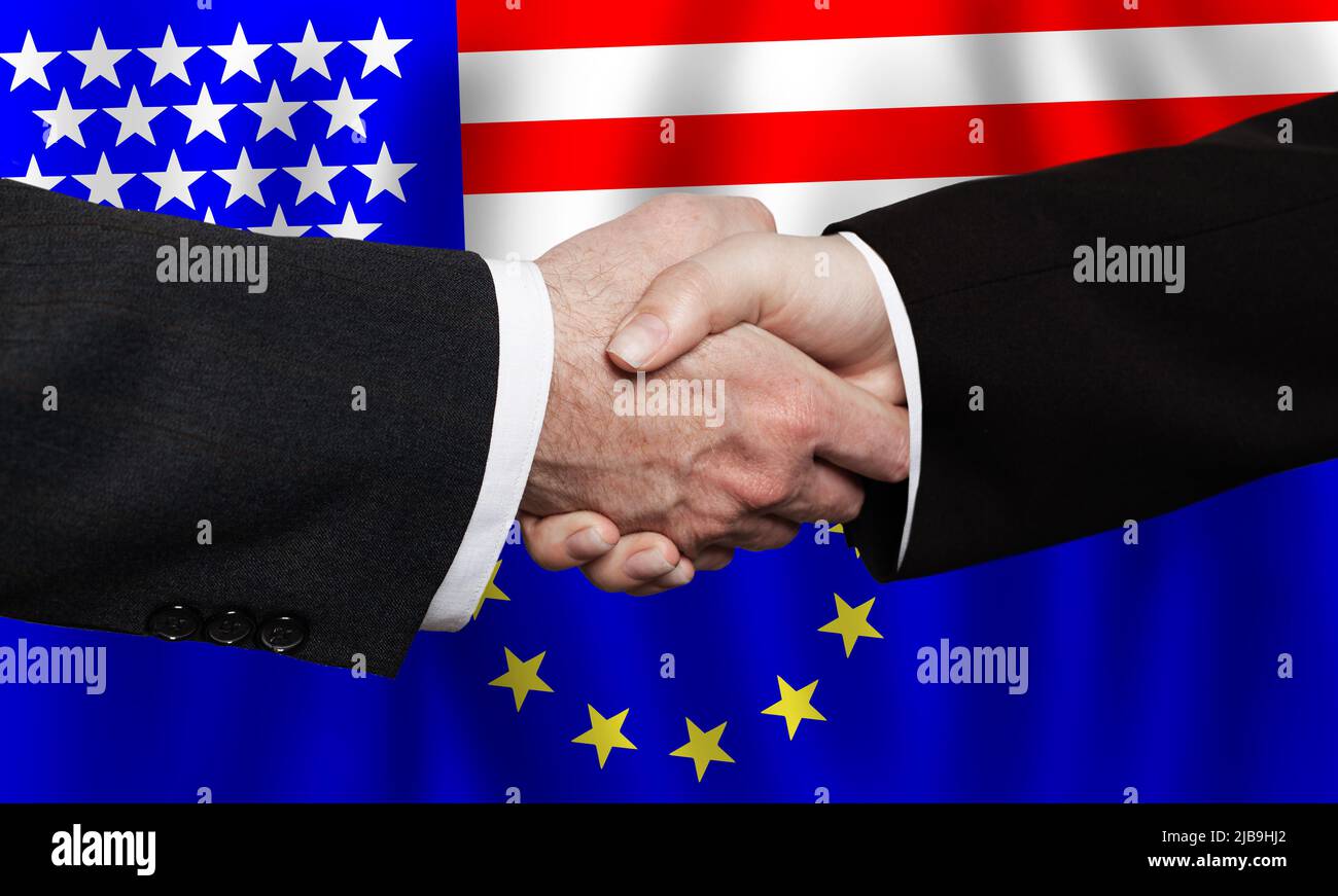 Handshake on USA and European Union flags background Stock Photo - Alamy