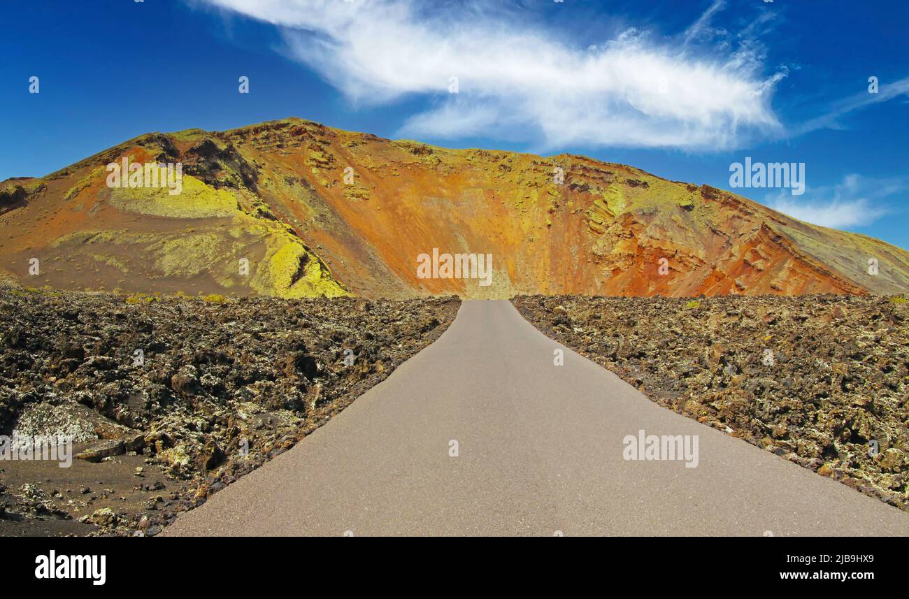 Road trip on empty asphalt route between volcanic lava rocks to red ...