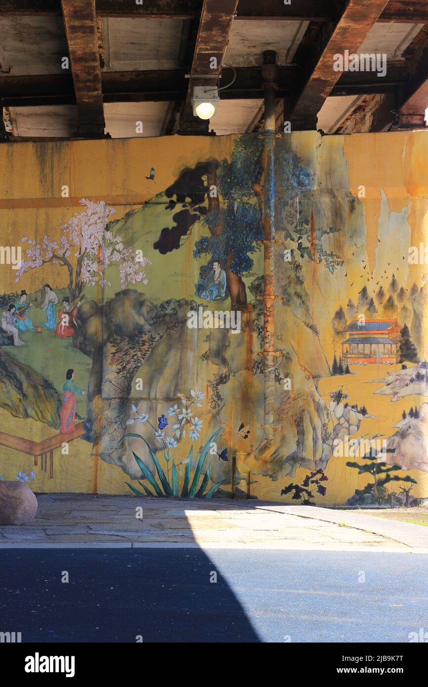 Chinese mural of an idyllic scene painted on the wall under the bridge ...