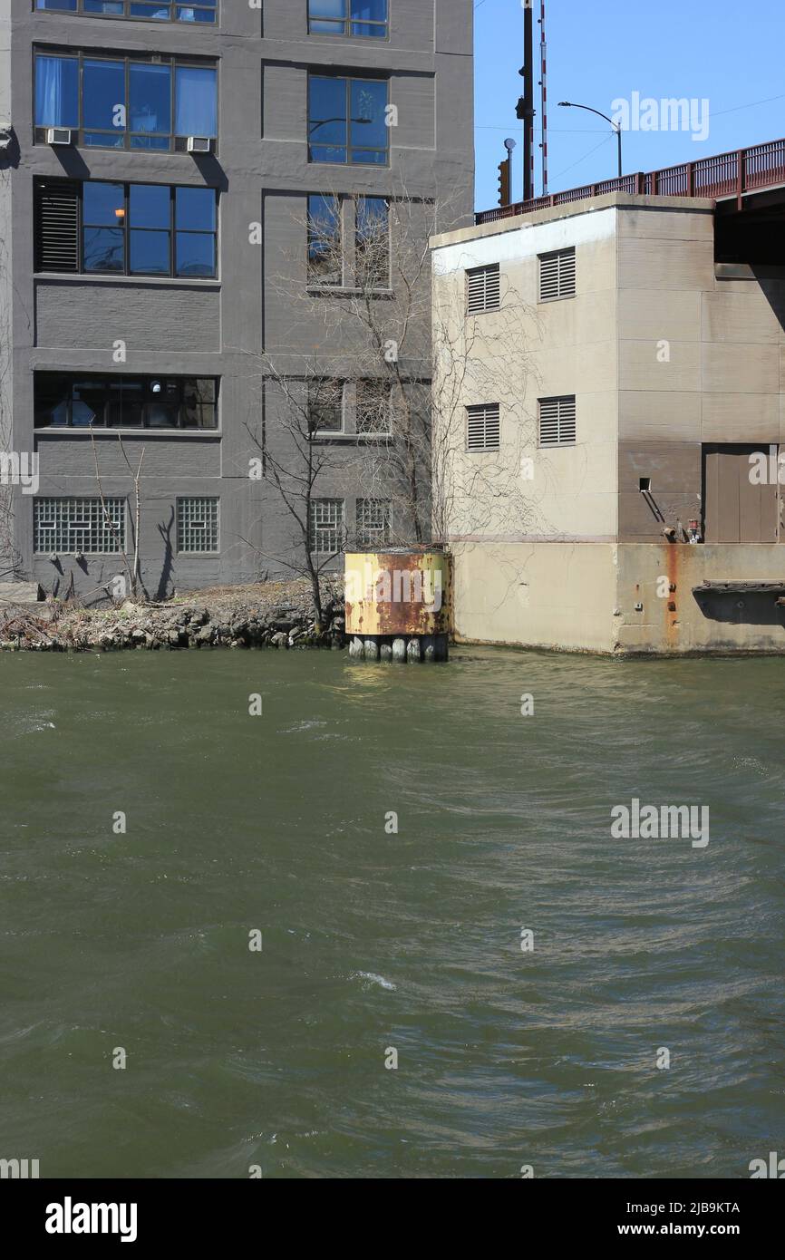Industrial warehouse building set on the riverfront near a bollard ...