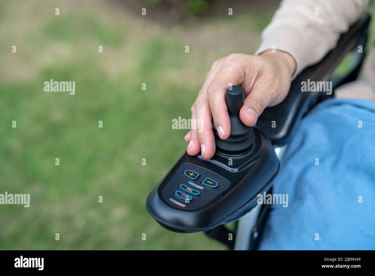 Asian lady woman patient on electric wheelchair with joystick and ...