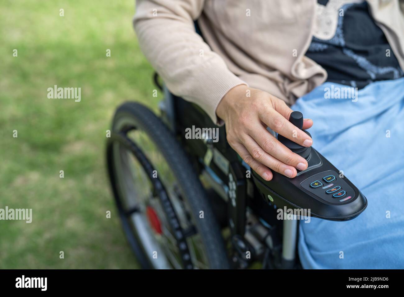 Asian lady woman patient on electric wheelchair with joystick and ...