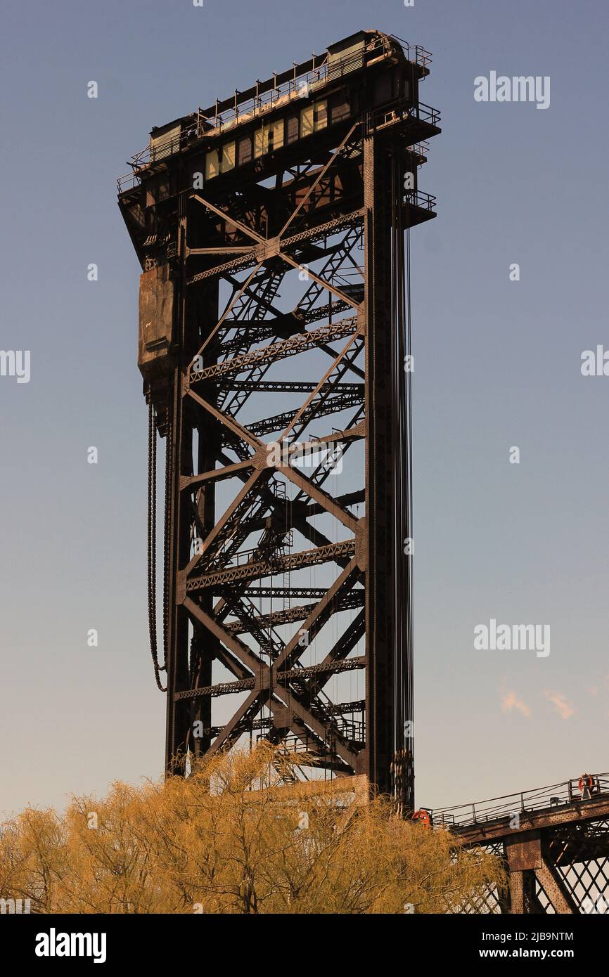 A very tall steel truss structure standing in the industrial district ...