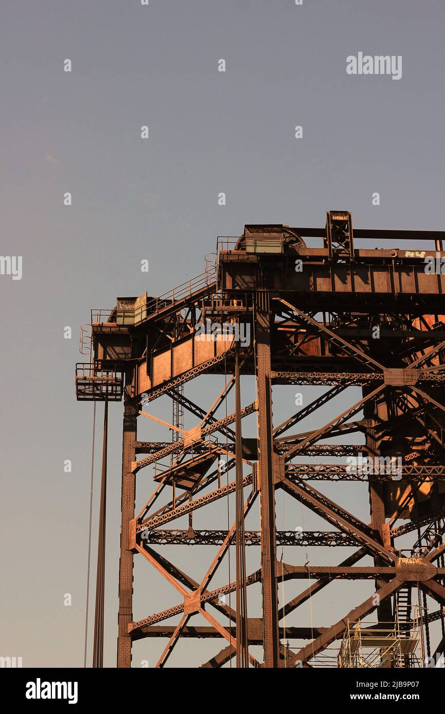 A very tall steel truss structure standing in the industrial district ...