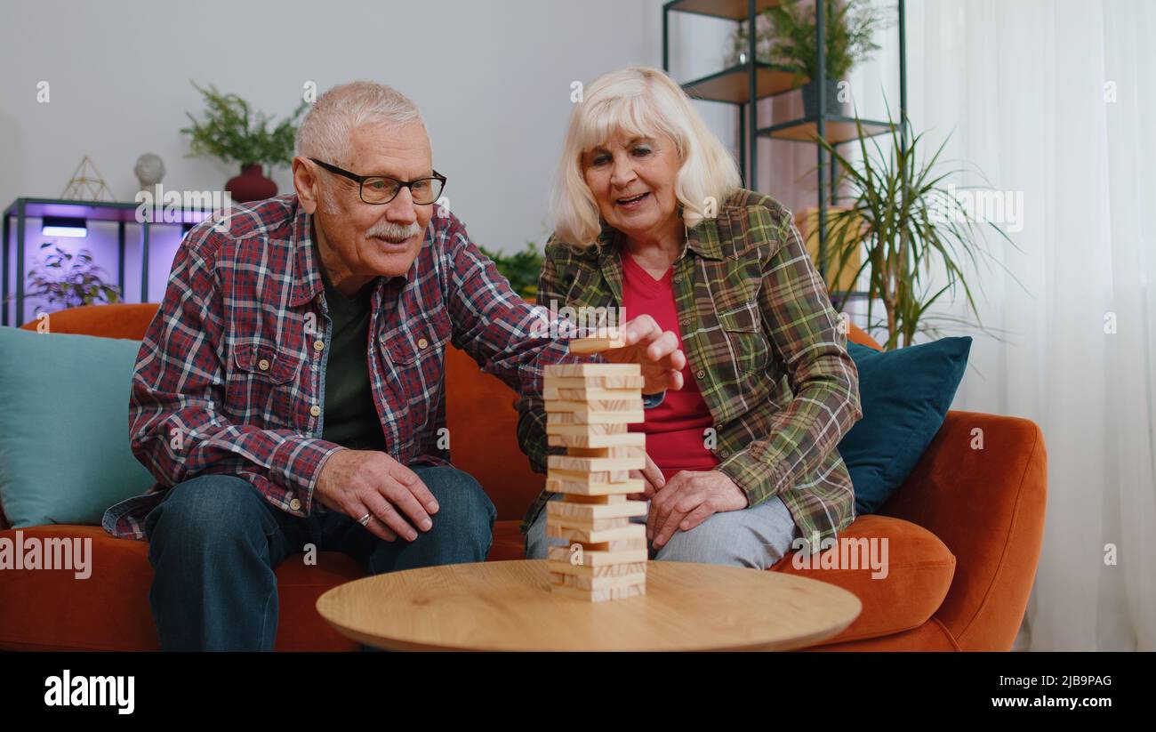 Old senior elderly family couple grandparents man woman playing in ...