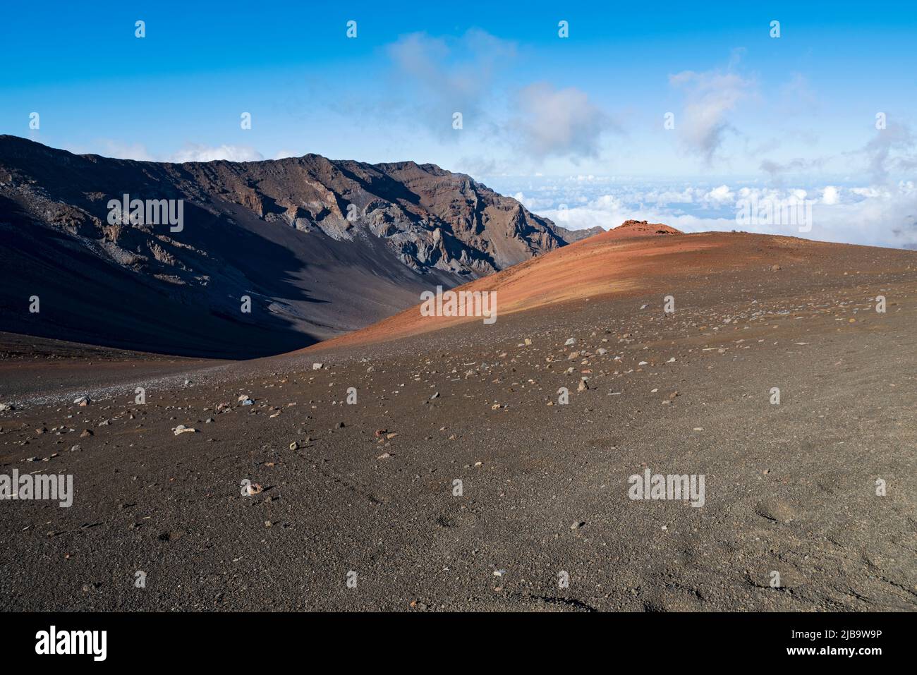 mountain ridge and sandy slopes of haleakala crater above clouds in ...