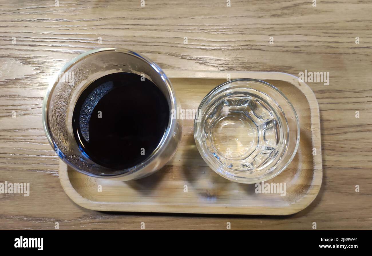 Coffee and water background, black coffee and a glass of water close ...