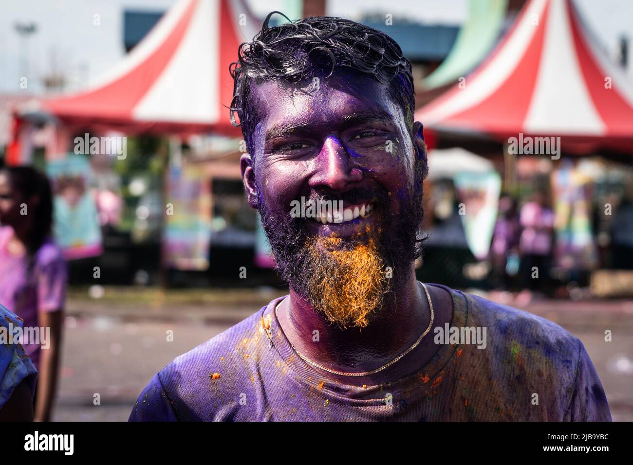 Penang, Malaysia. 04th June, 2022. A festival goer covered in colorful ...