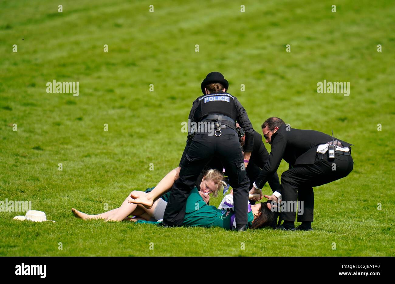 Protesters are removed from the track on Derby Day during the Cazoo ...
