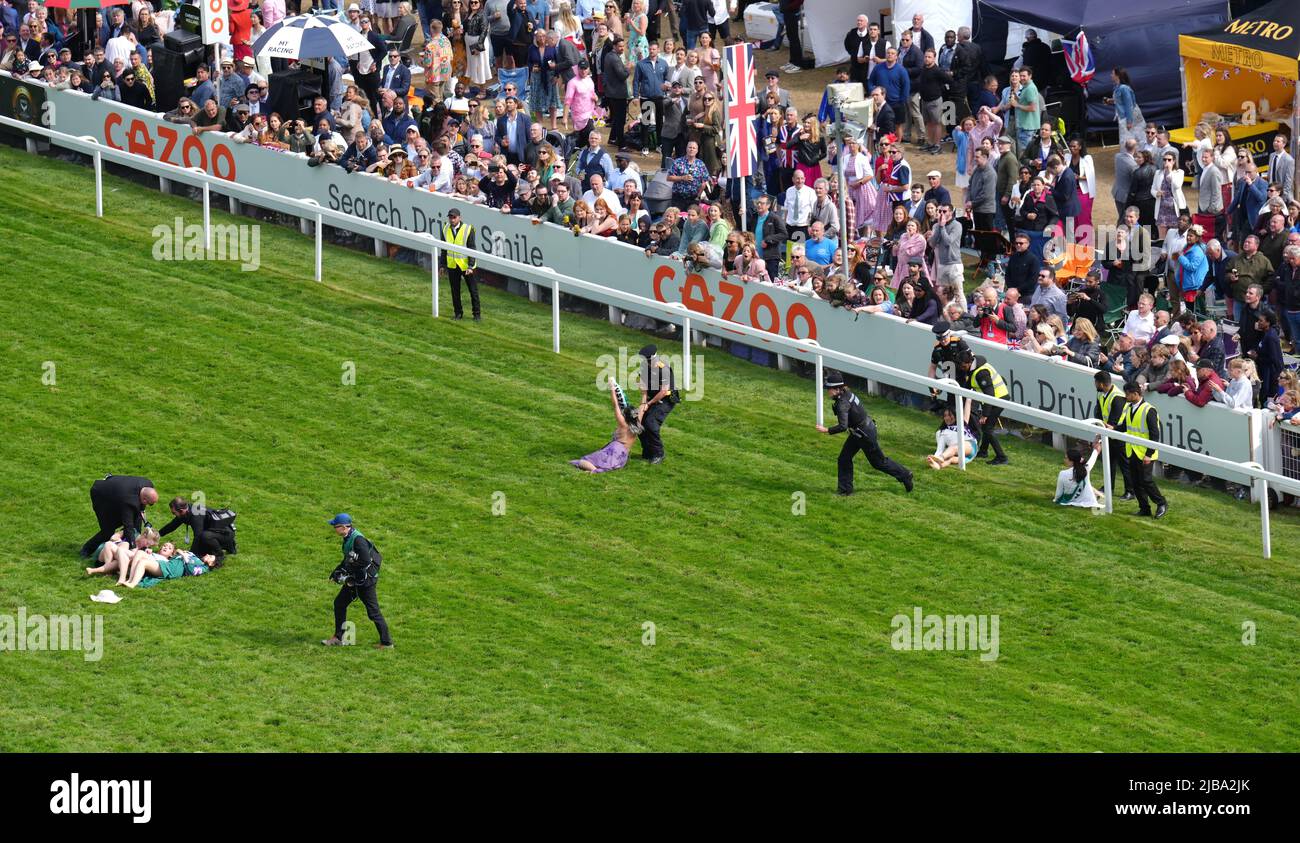 Protesters are removed from the track on Derby Day during the Cazoo ...