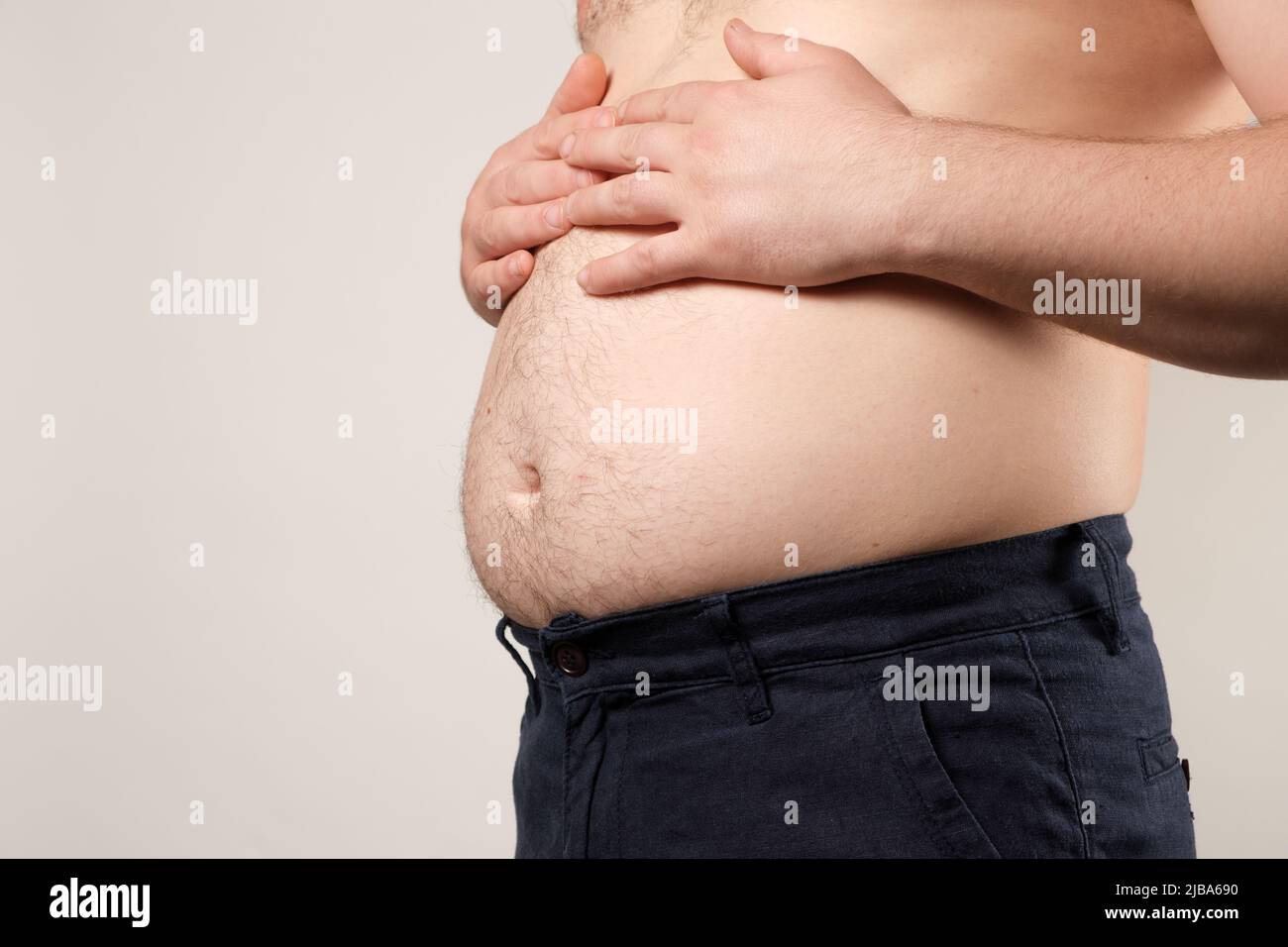 A man with a big sagging stomach, the concept of excess weight in men ...