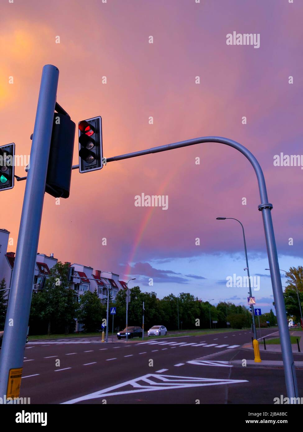 Traffic light in the city after the rain with a rainbow Stock Photo - Alamy