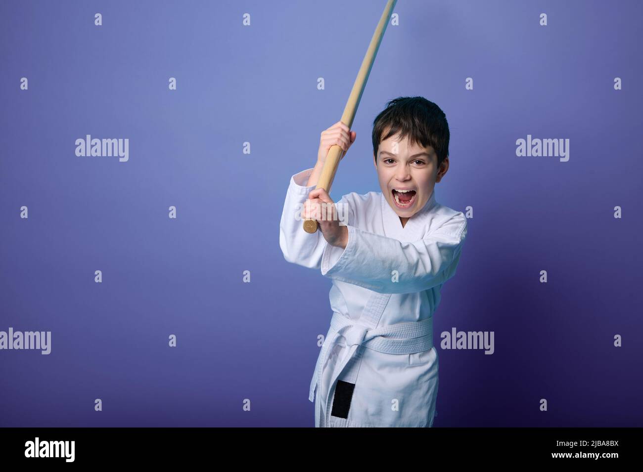 Portrait of a confident strong Caucasian child boy aikido wrestler ...