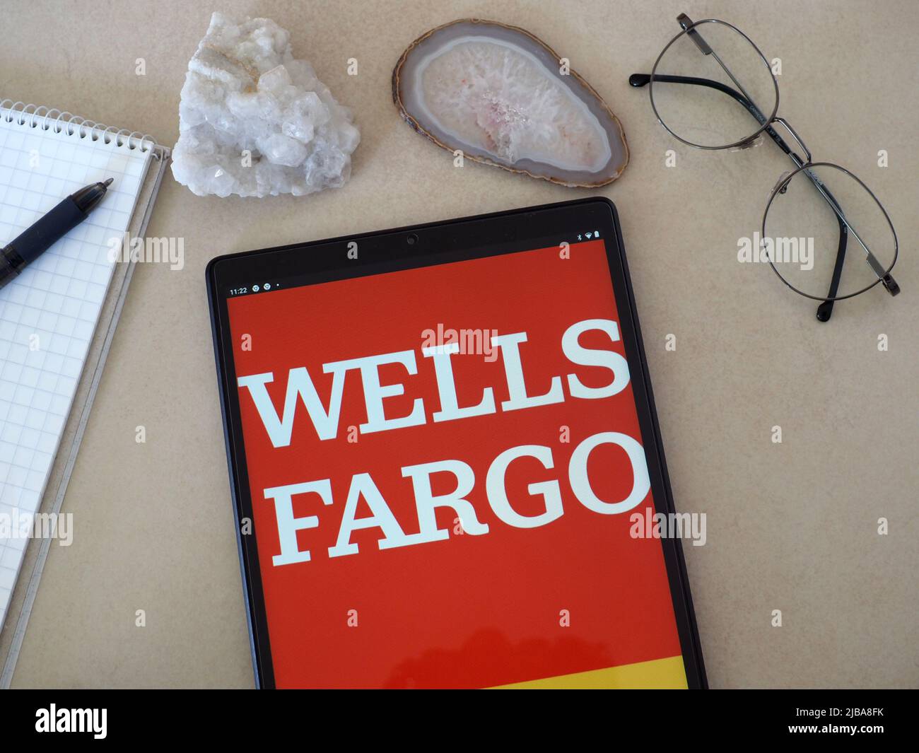 In this photo illustration a Wells Fargo & Company logo seen displayed ...