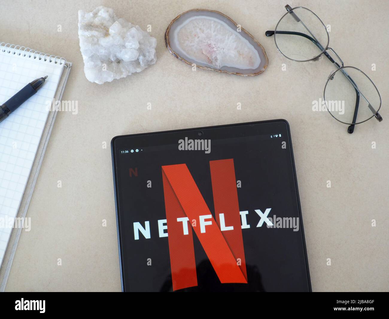 In this photo illustration a Netflix logo seen displayed on a tablet ...