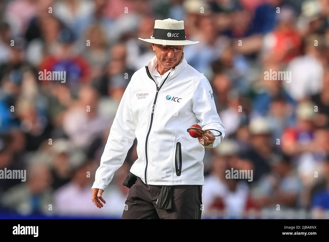 Umpire Rod Tucker checks the ball before offering England a new ball ...