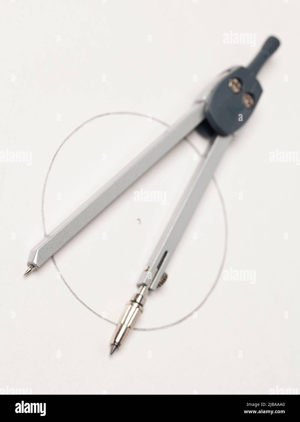 Metallic drawing compass isolated on white background Stock Photo - Alamy