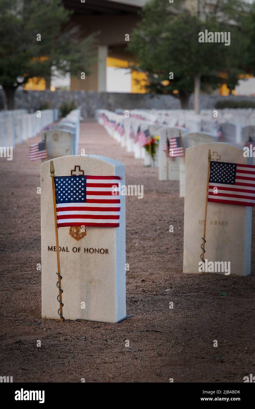 An American flag waves over a Medal of Honor grave at the Fort Bliss National Cemetery in El ...