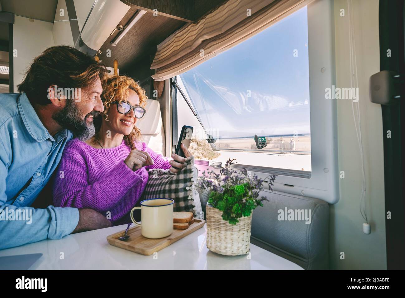 Tourist young adult people enjoy phone connection and freedom sitting ...
