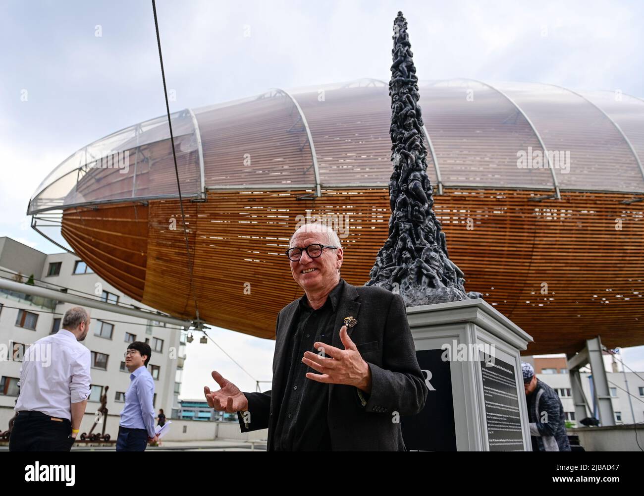 The Pillar of Shame statue by Danish artist Jens Galschiot (front) to ...