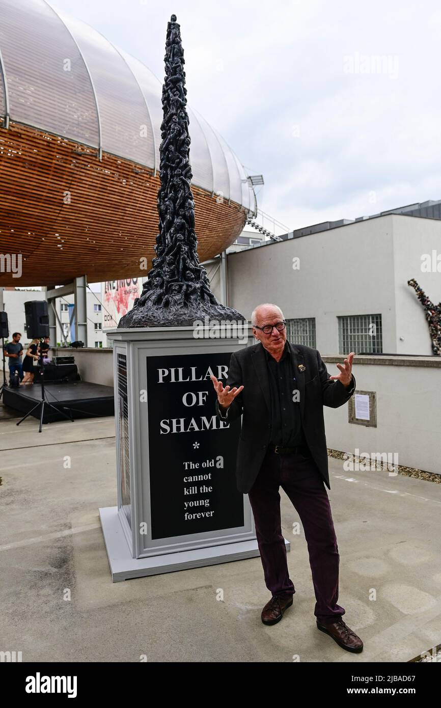 The Pillar of Shame statue by Danish artist Jens Galschiot (front) to ...